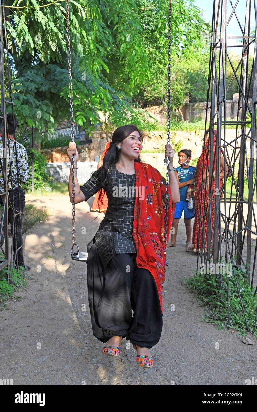 Beawar, Rajasthan, India, July 27, 2020: Young girl swing at a park ...