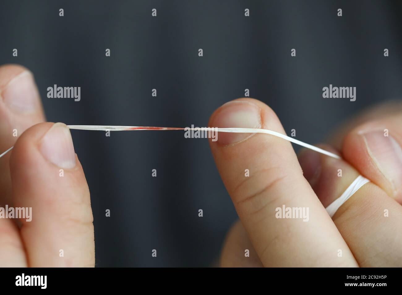 Hold dental floss with blood in your hands Stock Photo - Alamy