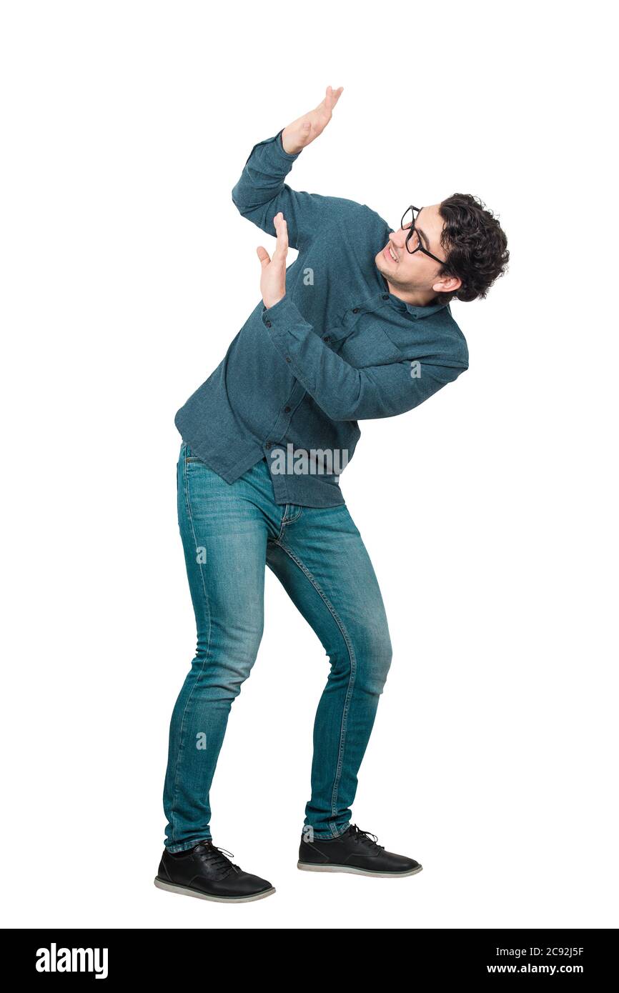Full length portrait scared man keeps hands raised up to protect him ...