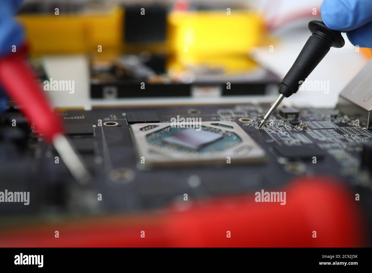 Master makes diagnostics of motherboard with tester Stock Photo - Alamy