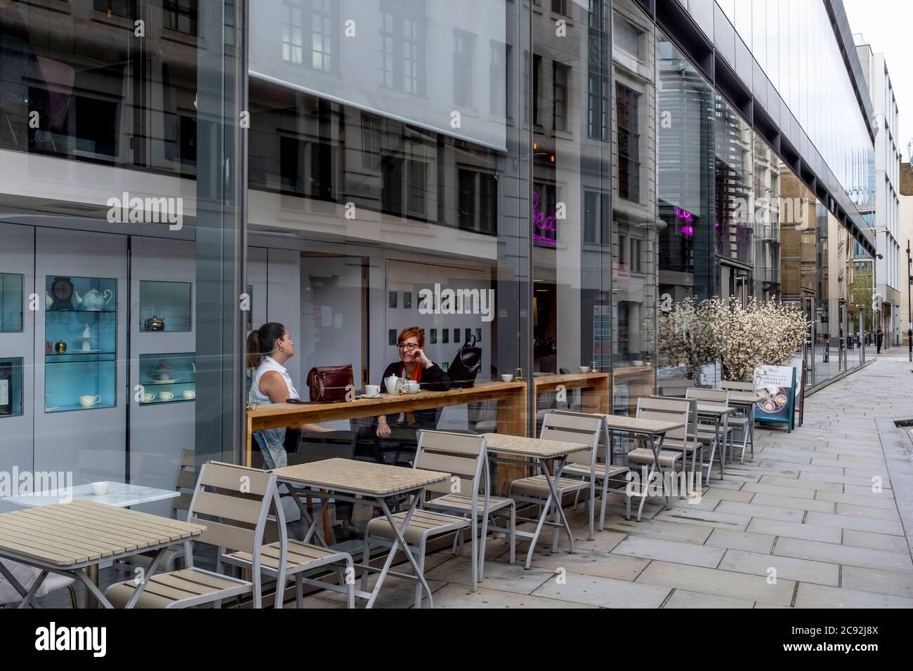 Two Women Sitting At A Cafe In Watling Street, London, England Stock ...