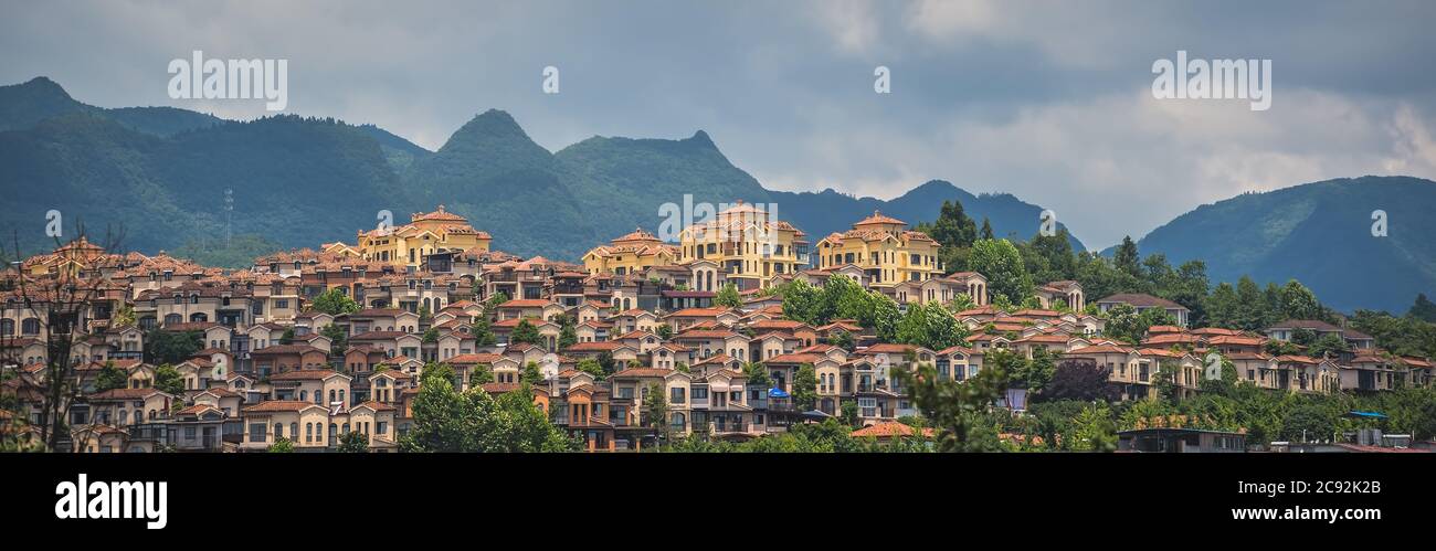 Hillside homes, houses and resorts in a town near entrance to the ...