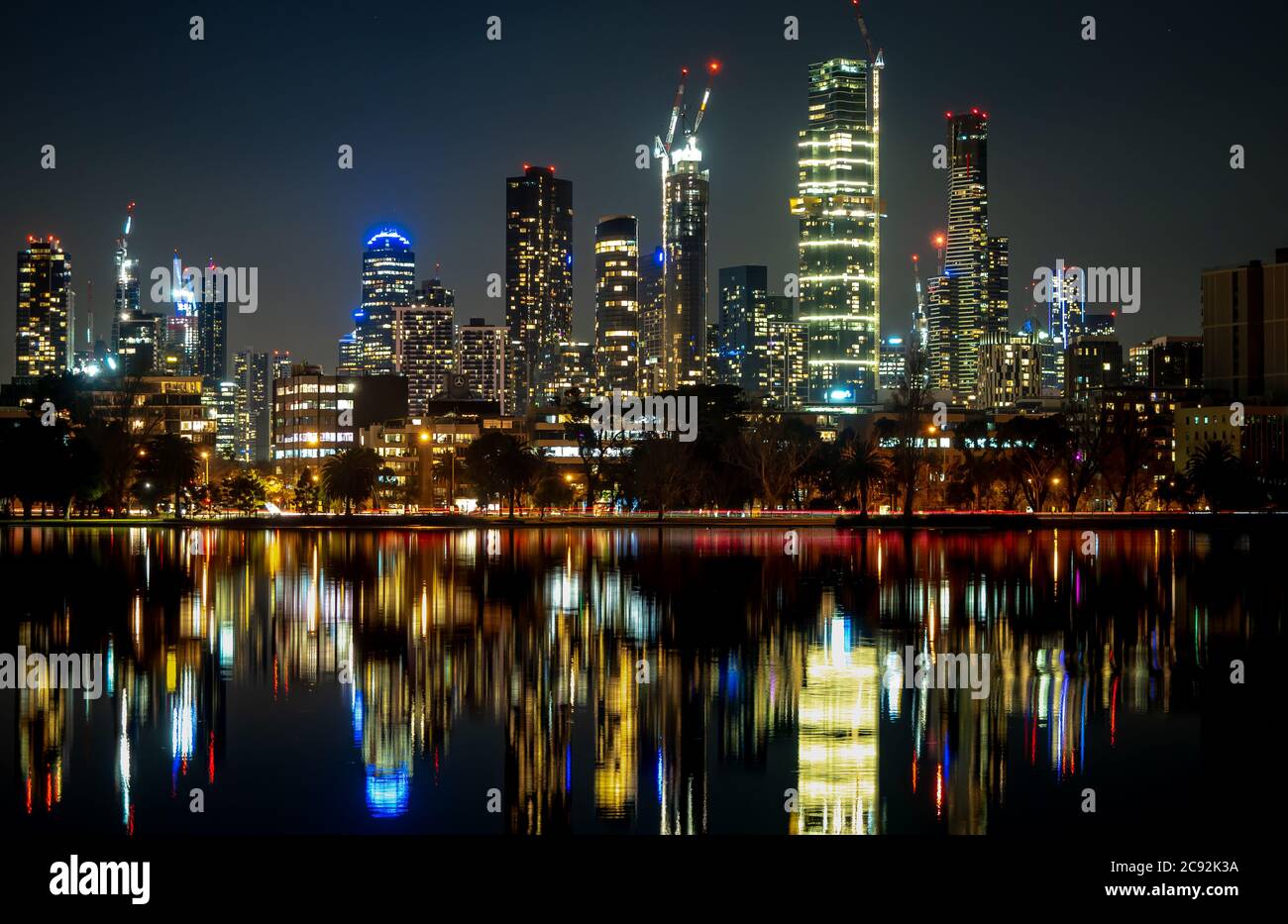 The reflections of the melbourne city skyline at dusk in the still ...