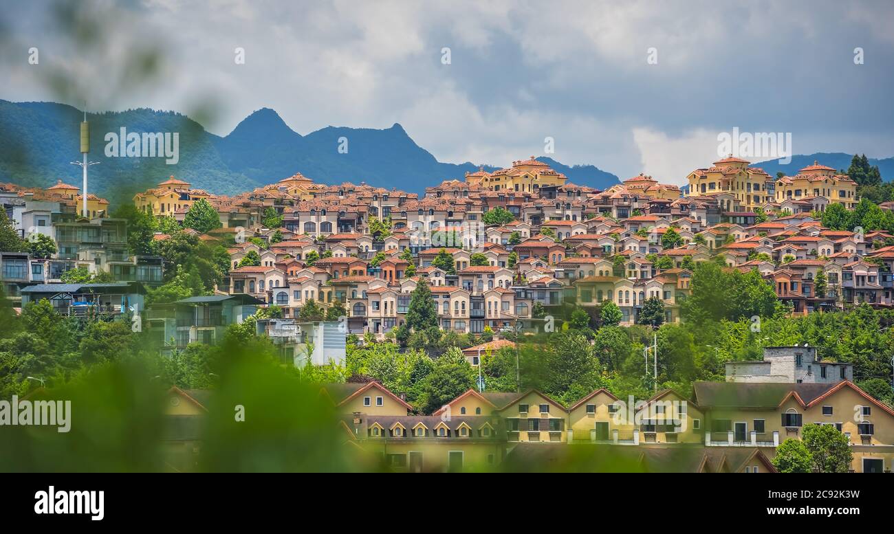 Hillside homes, houses and resorts in a town near entrance to the ...