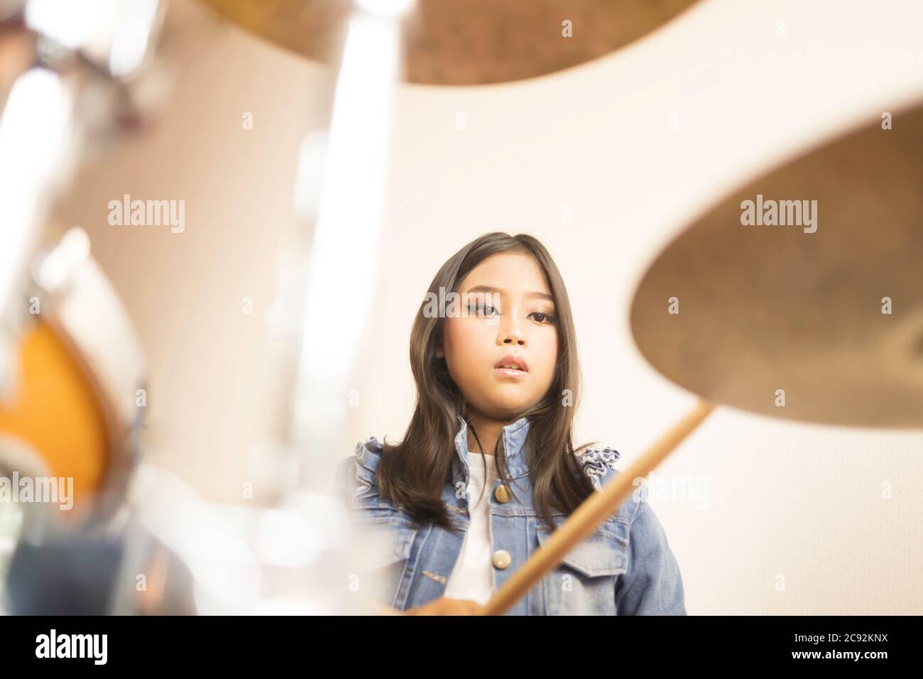 Asian girl playing drum hi-res stock photography and images - Alamy