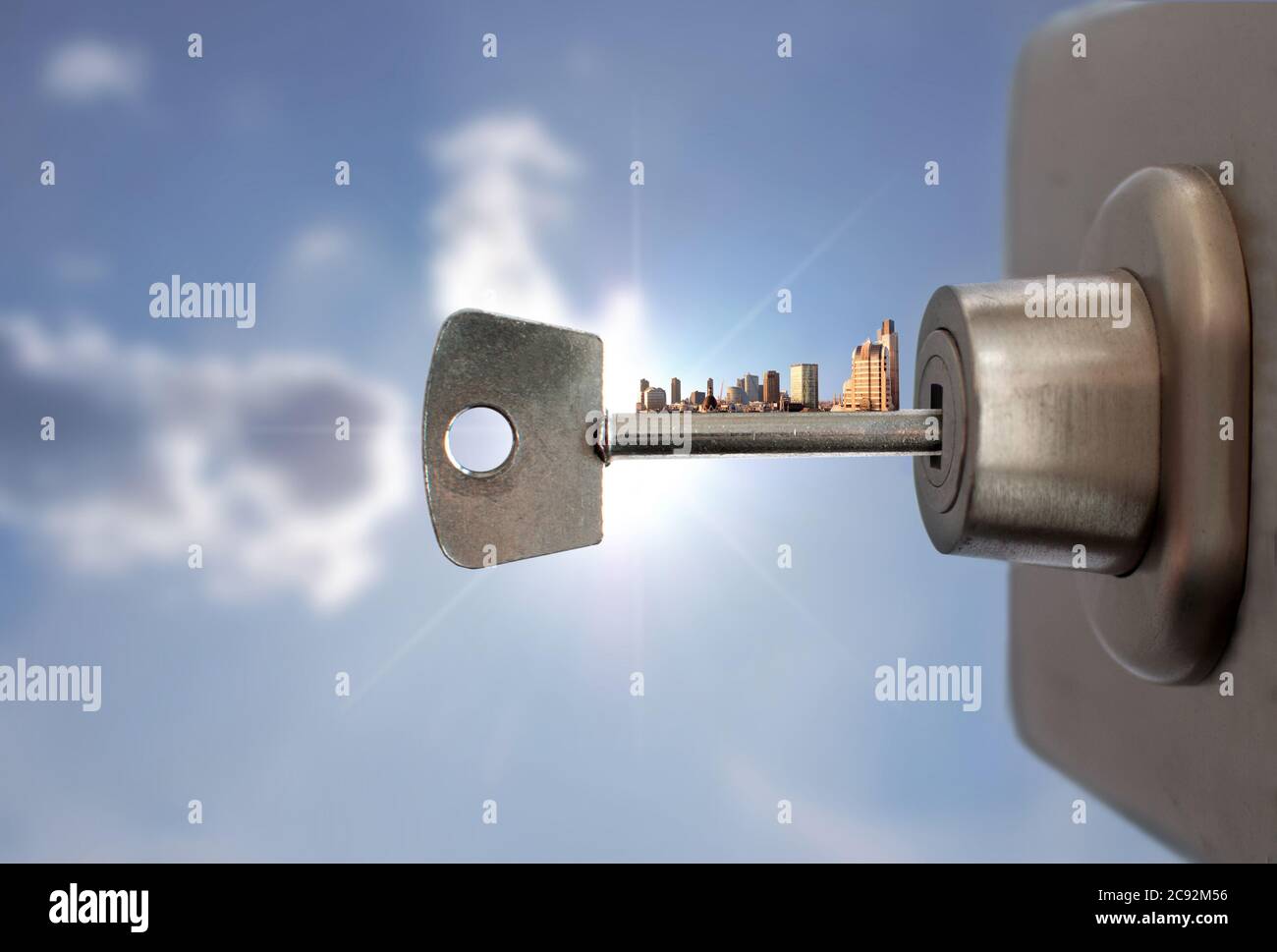 Key with city skyline inside a door lock Stock Photo - Alamy
