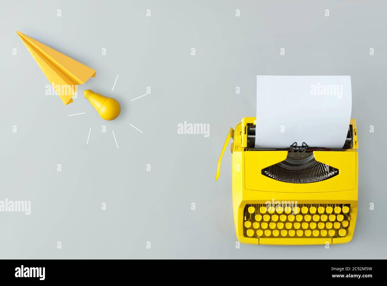 Retro typewriter with yellow paper airplane, and light bulb inspiration ...