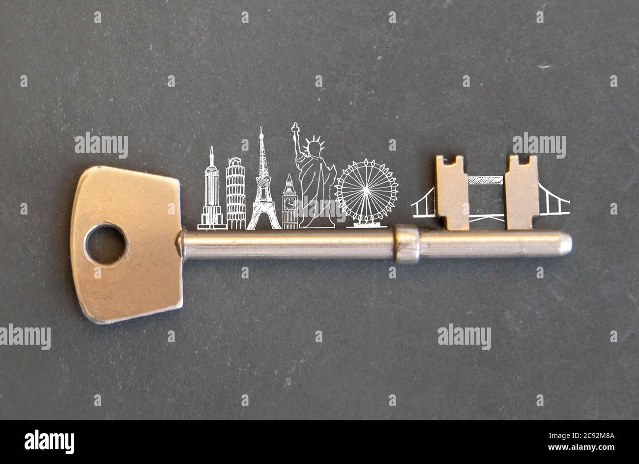 Gold key with skyline sketch of global landmarks Stock Photo - Alamy