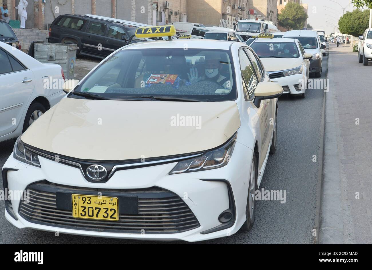 Kuwait City, Kuwait. 28th July, 2020. A taxi driver gestures after he resumes work in Kuwait ...