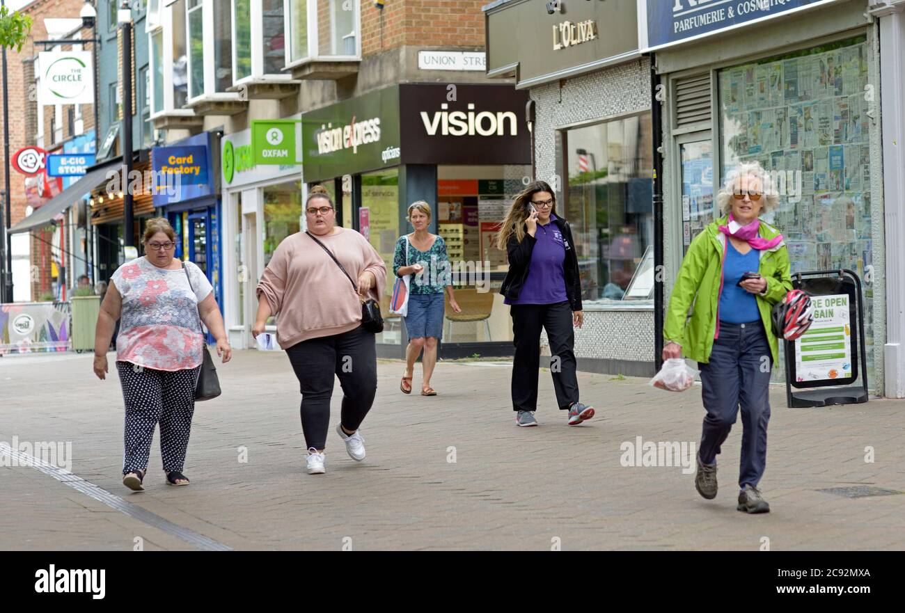 Two obese women walking along the street Stock Photo - Alamy