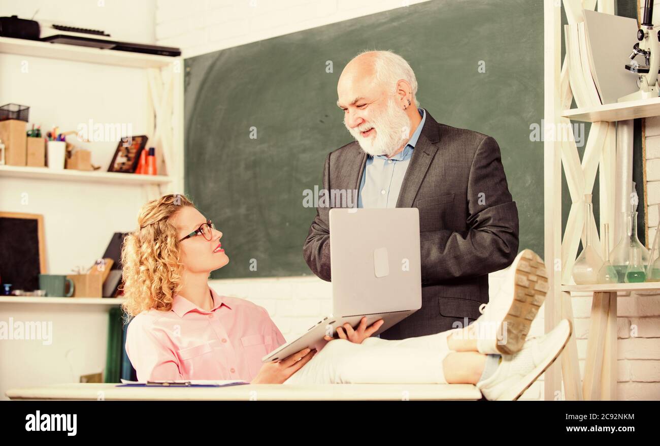 School assignment. senior teacher and woman at school lesson. student ...