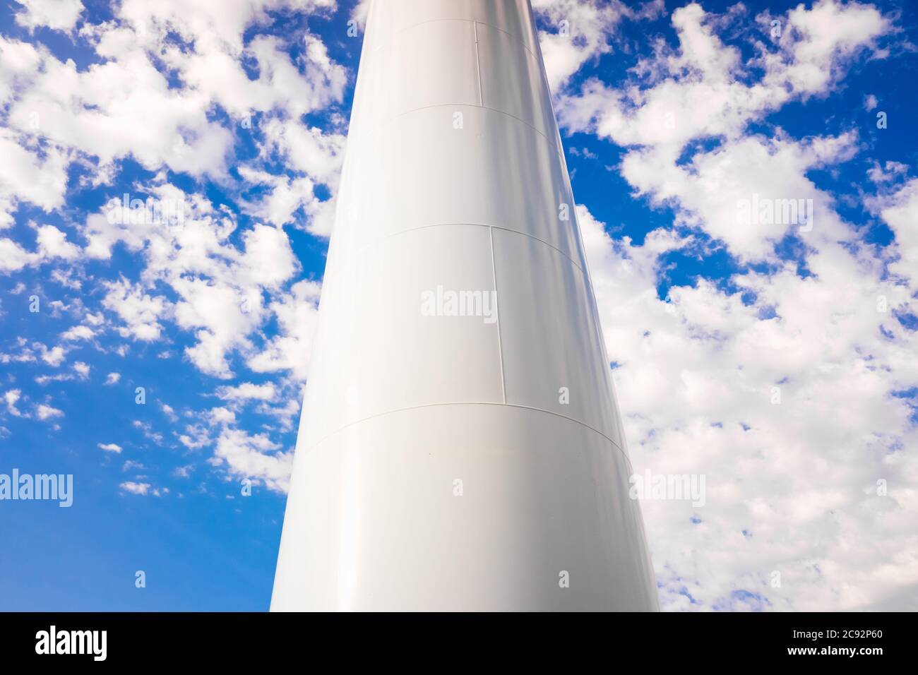 Thick metallic white pipe in vertical position as base of a tower ...