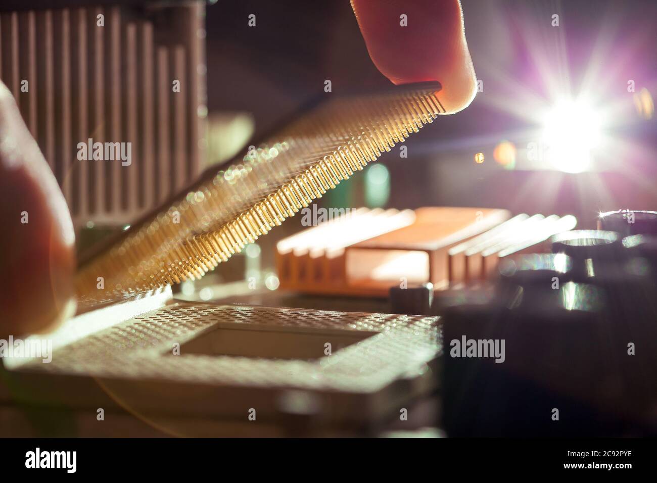 Technician plug in CPU microprocessor to motherboard socket, evident ...