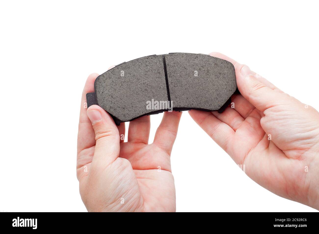 Brake pads in the engineer's hand, isolated Stock Photo - Alamy