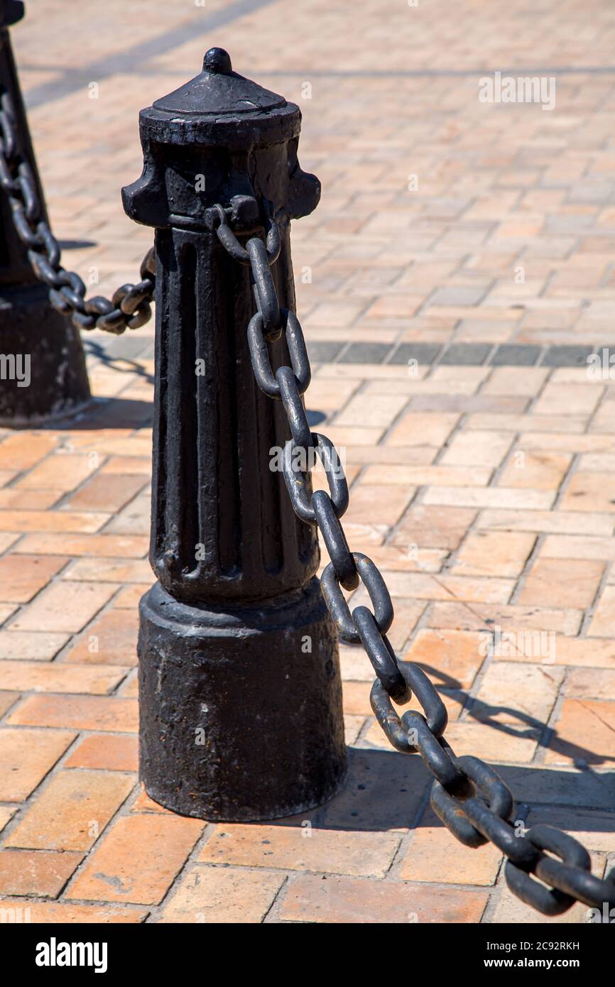 bollard cast-iron black color with chains against the background of ...