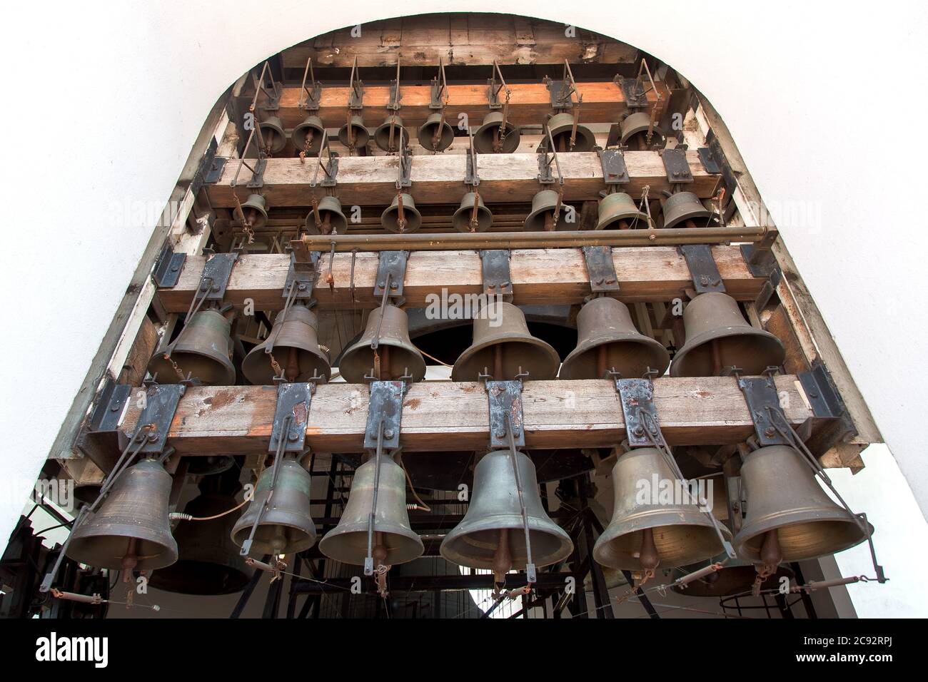 The church bell tower, the bells on wooden beams are lined up in ...