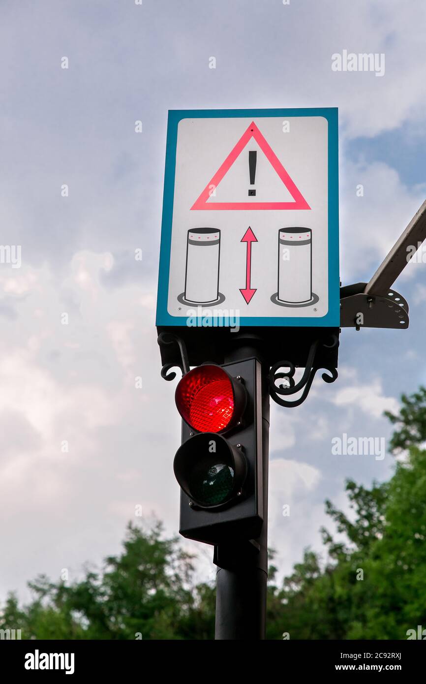 Traffic light with warning sign - Attention automatic retractable ...