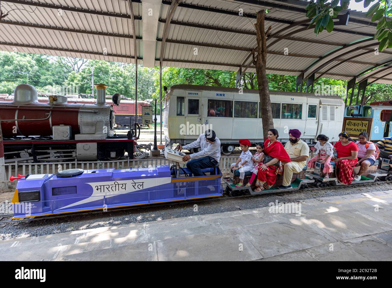 Visitors enjoy a ride on a small joy train inside the Railway Museum in ...