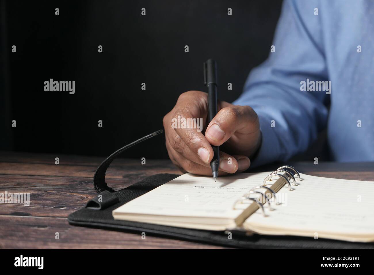 Close up of man hand writing on notepad Stock Photo - Alamy