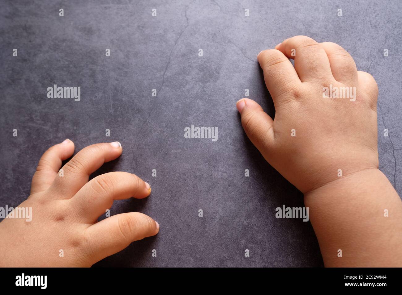top view of baby hand on black background Stock Photo - Alamy