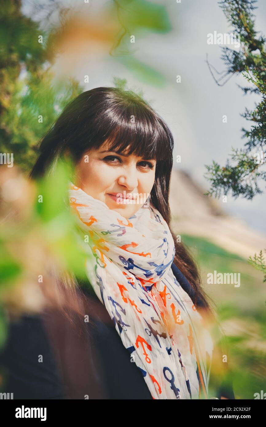 Happy smiling beautiful overweight young woman in dark blue jacket and ...