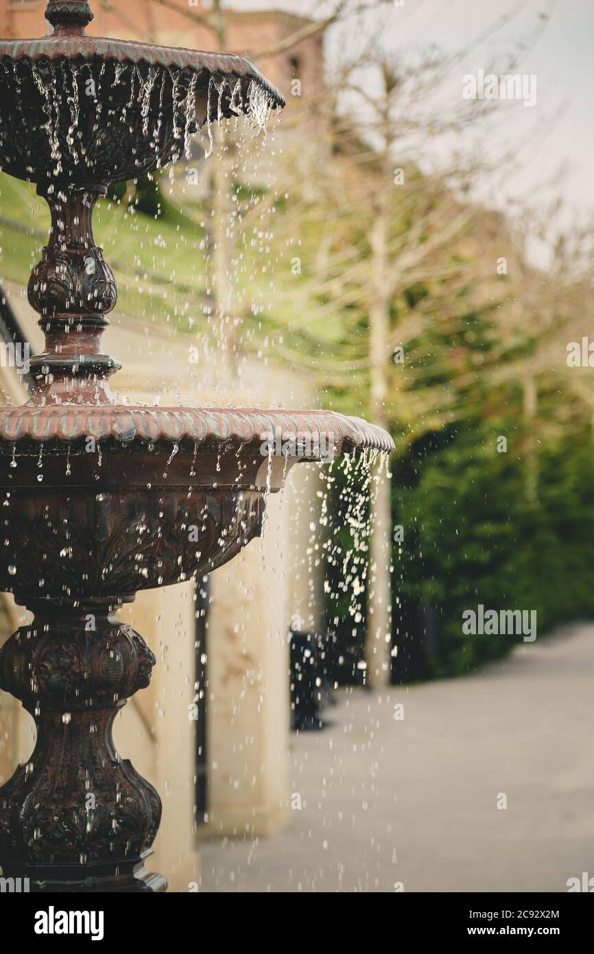 Detail of an old classic style fountain with flowing water. Outdoor ...