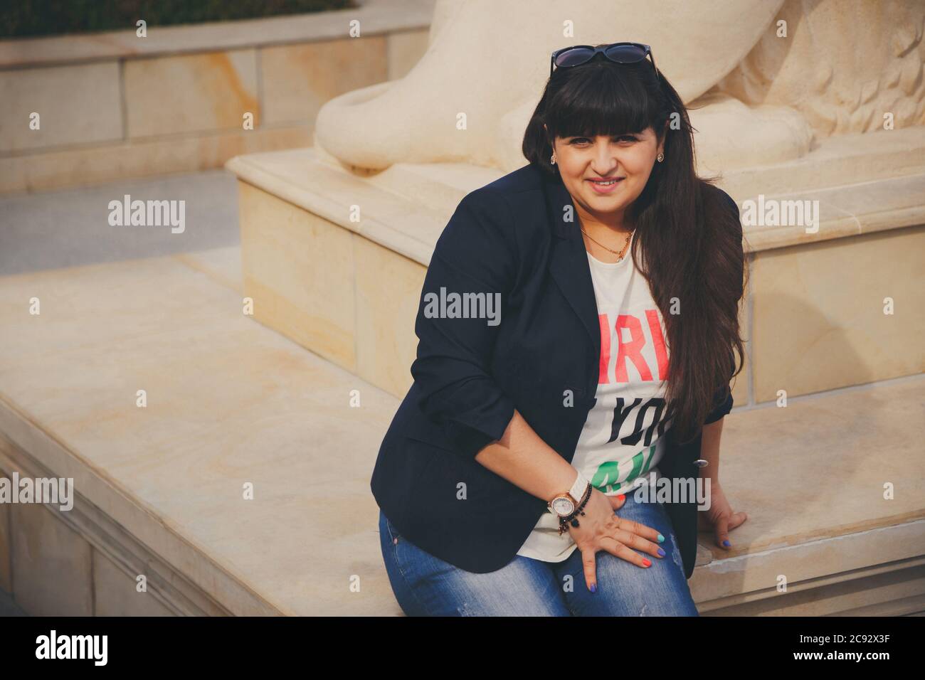 Happy smiling beautiful overweight young woman in dark blue jacket ...