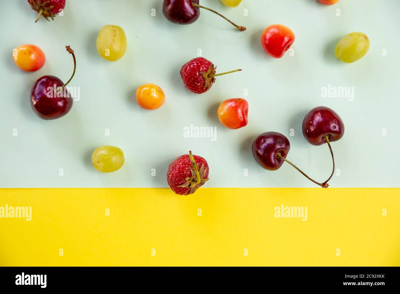 Various berries isolated on colorful background, top view. Berry border ...