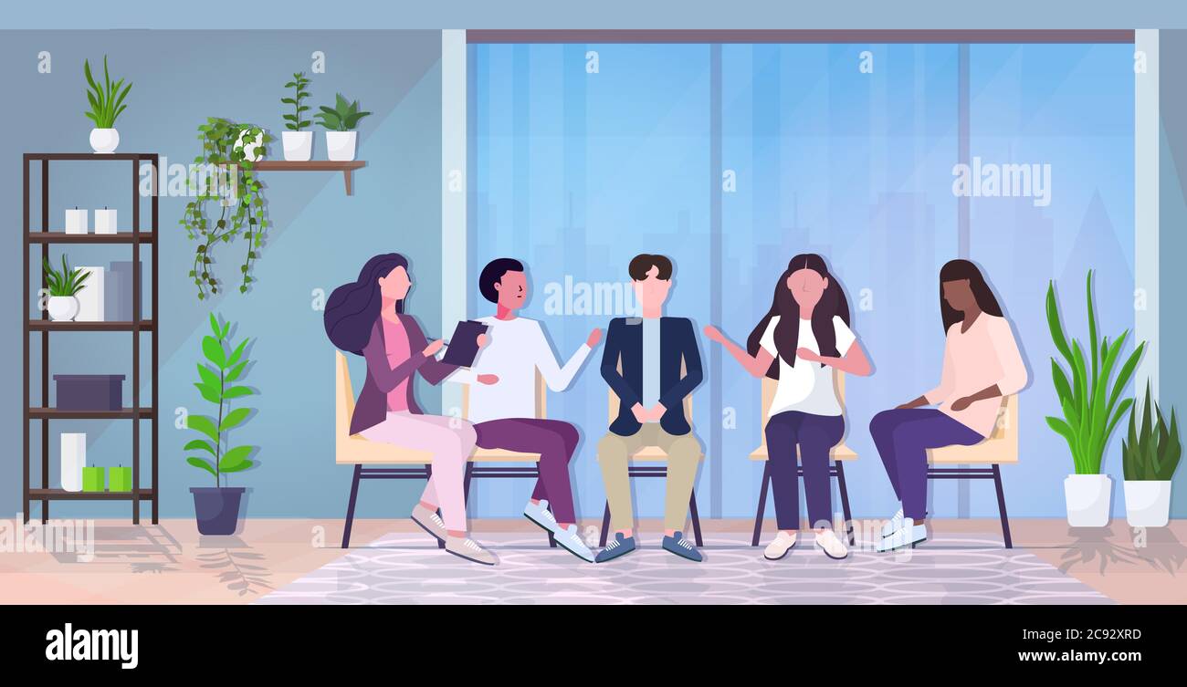 Female Psychologist Talking With Patients Group During Psychotherapy