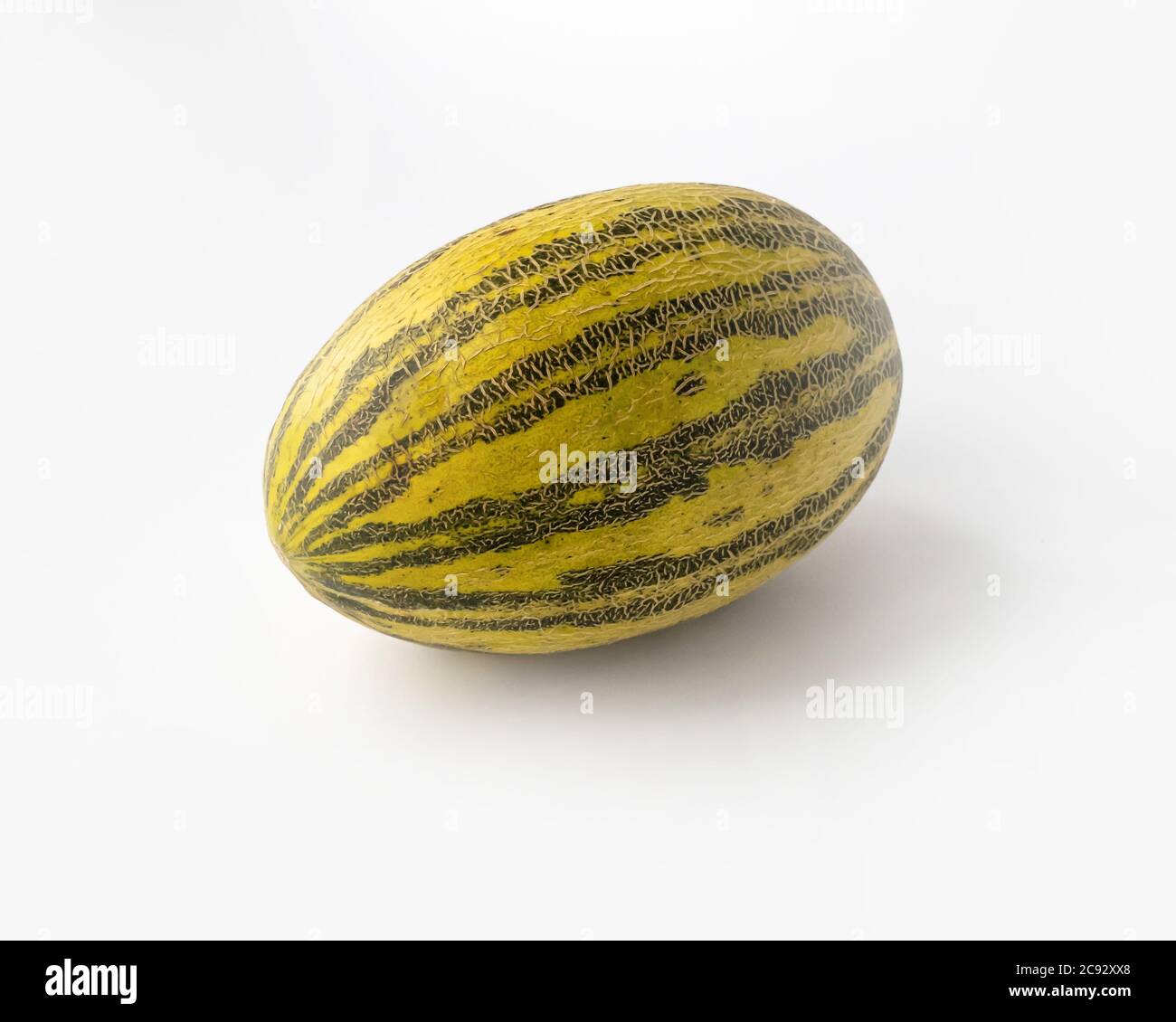 Striped yellow with green stripes oblong melon on a white background ...