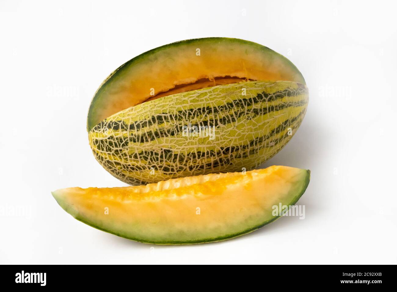 Striped yellow with green stripes an oblong melon with a carved slice ...