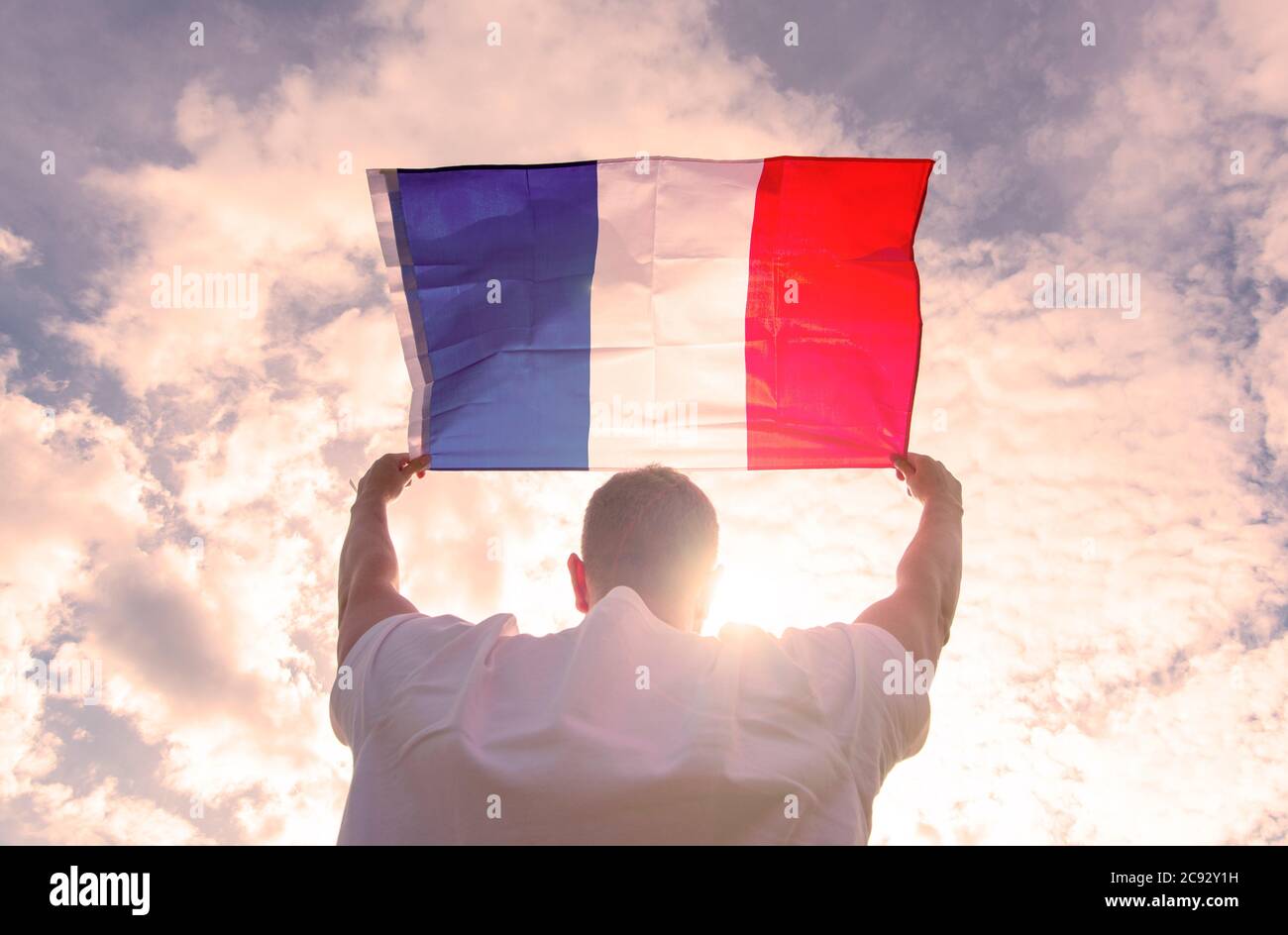 Man holding Flag of France, concept picture Stock Photo - Alamy