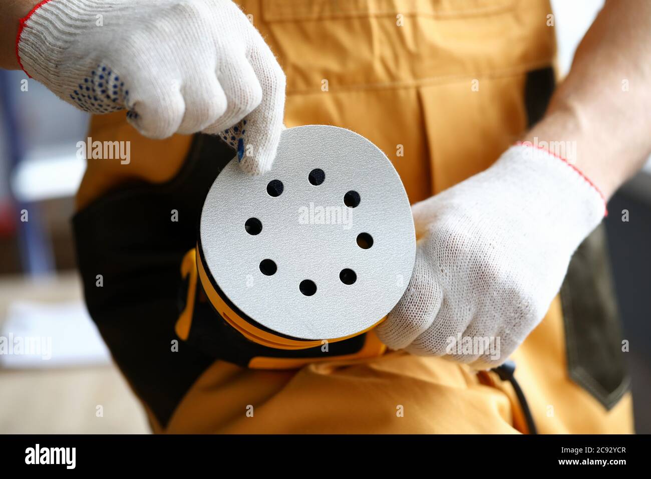 Craftsman in orange costume Stock Photo - Alamy