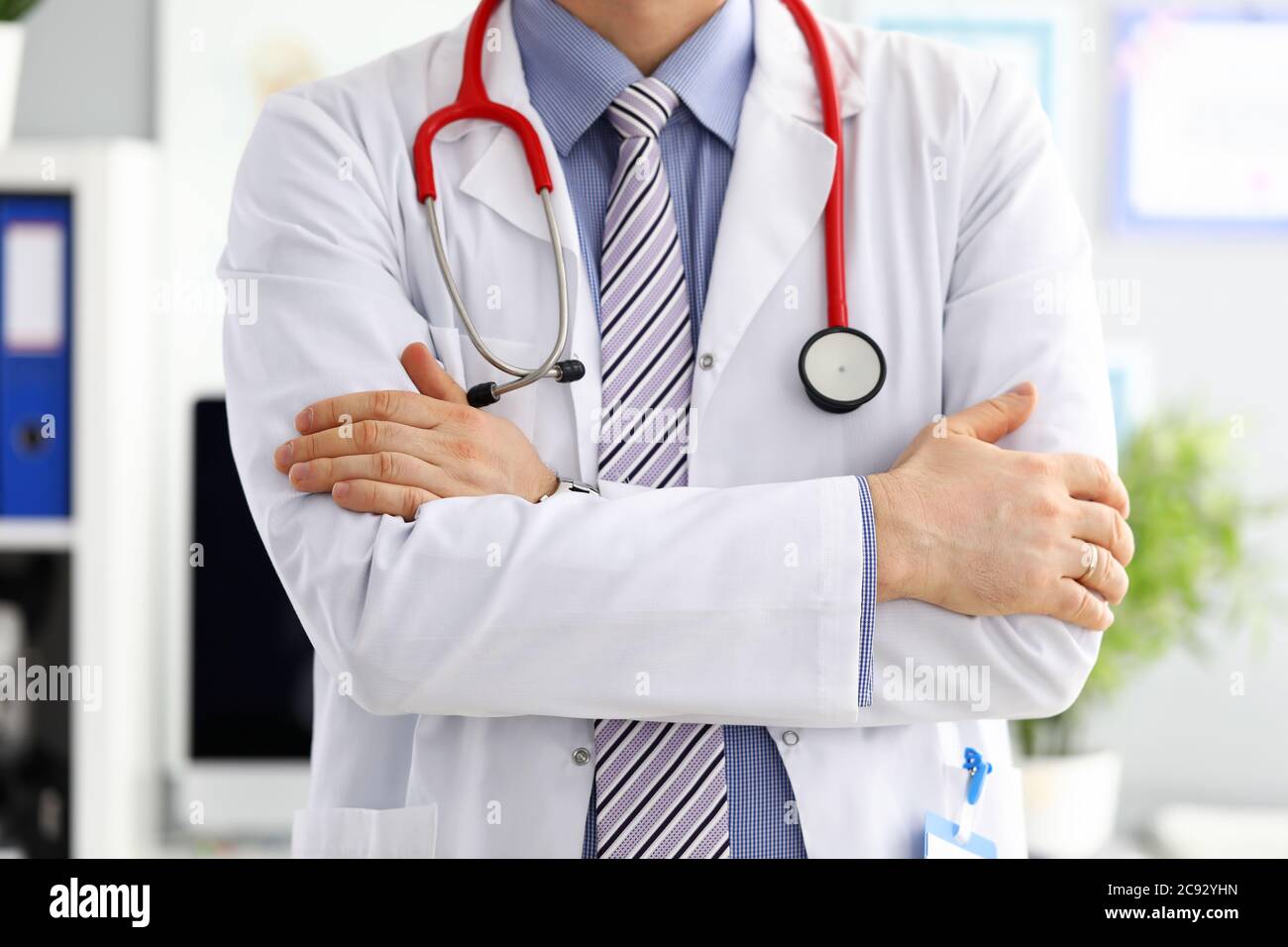 Male medicine doctor hands crossed on his chest Stock Photo - Alamy