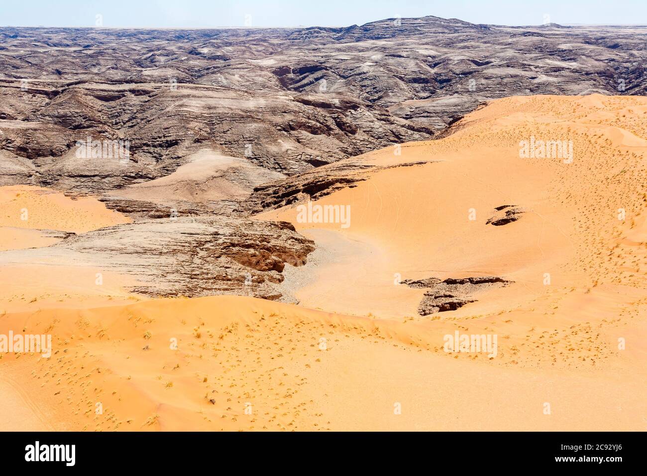 Typical bleak, arid mountainous terrain of the Namib Desert with ochre ...