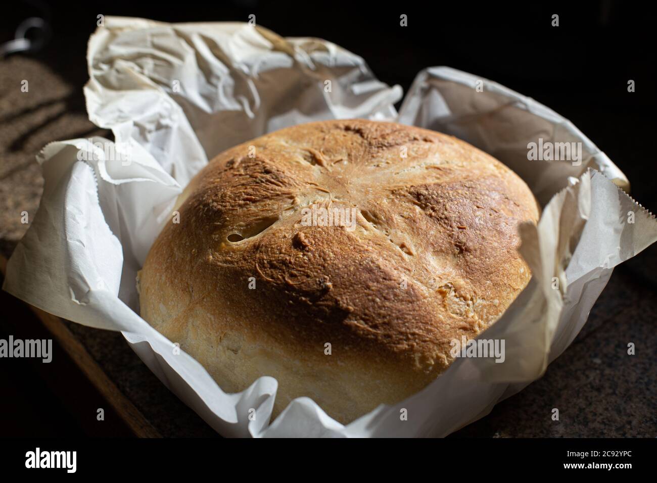 Freshly made bread sitting on counter in sunshine Stock Photo - Alamy