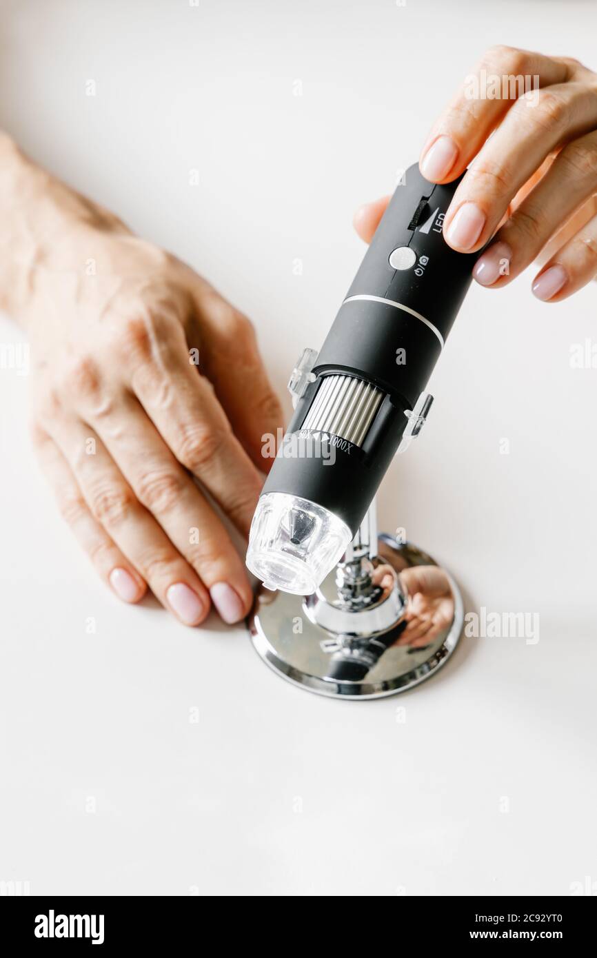 Skin microscope in hands Stock Photo - Alamy