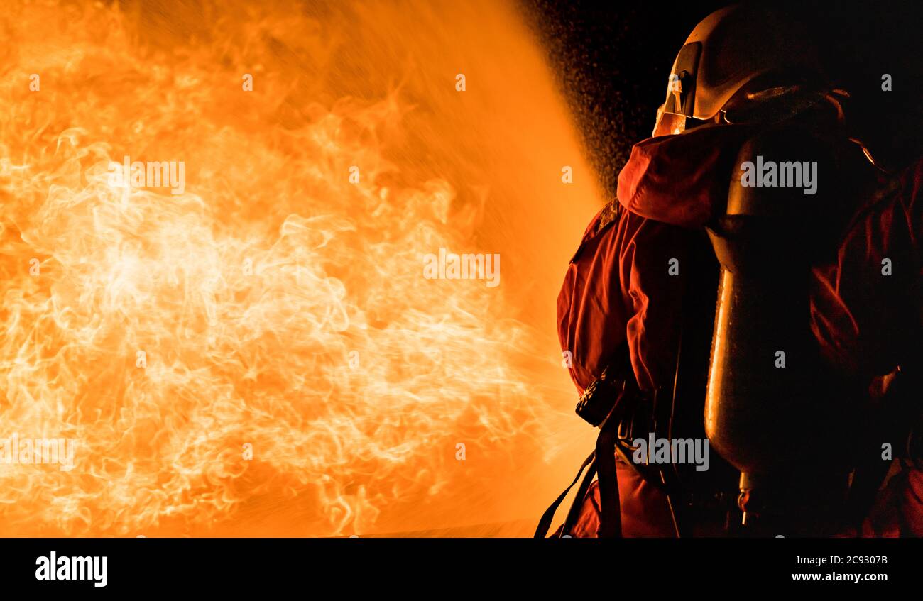 Firefighters using Twirl water fog type fire extinguisher to fighting ...