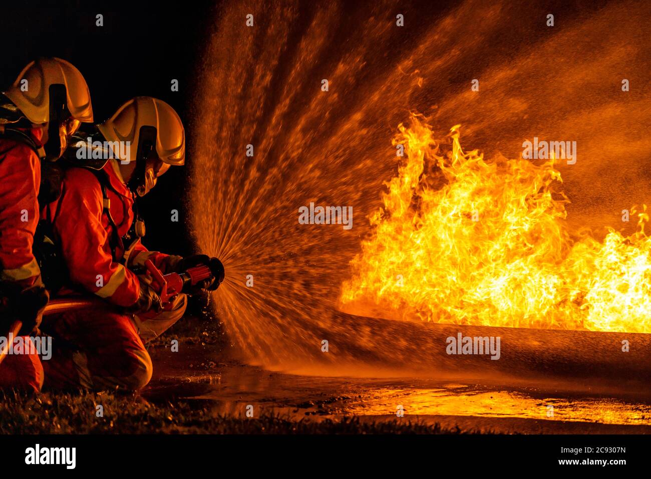 Firefighters using Twirl water fog type fire extinguisher to fighting ...