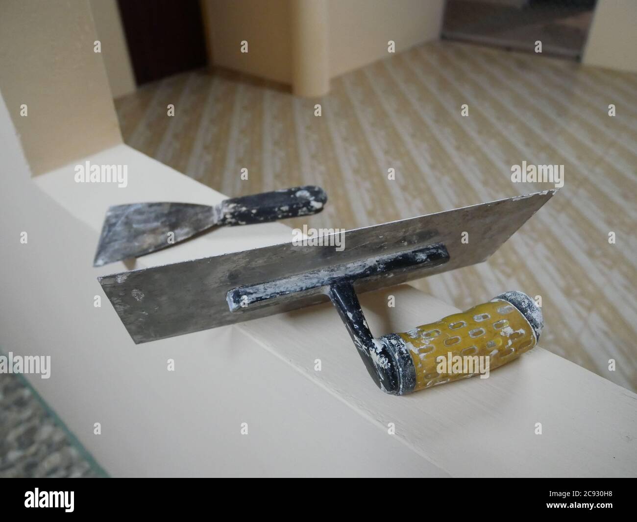 trowel on concrete wall, construction building tools Stock Photo - Alamy