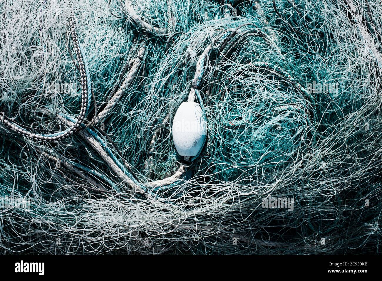 Fishermans nets and buoy tangled together Stock Photo - Alamy