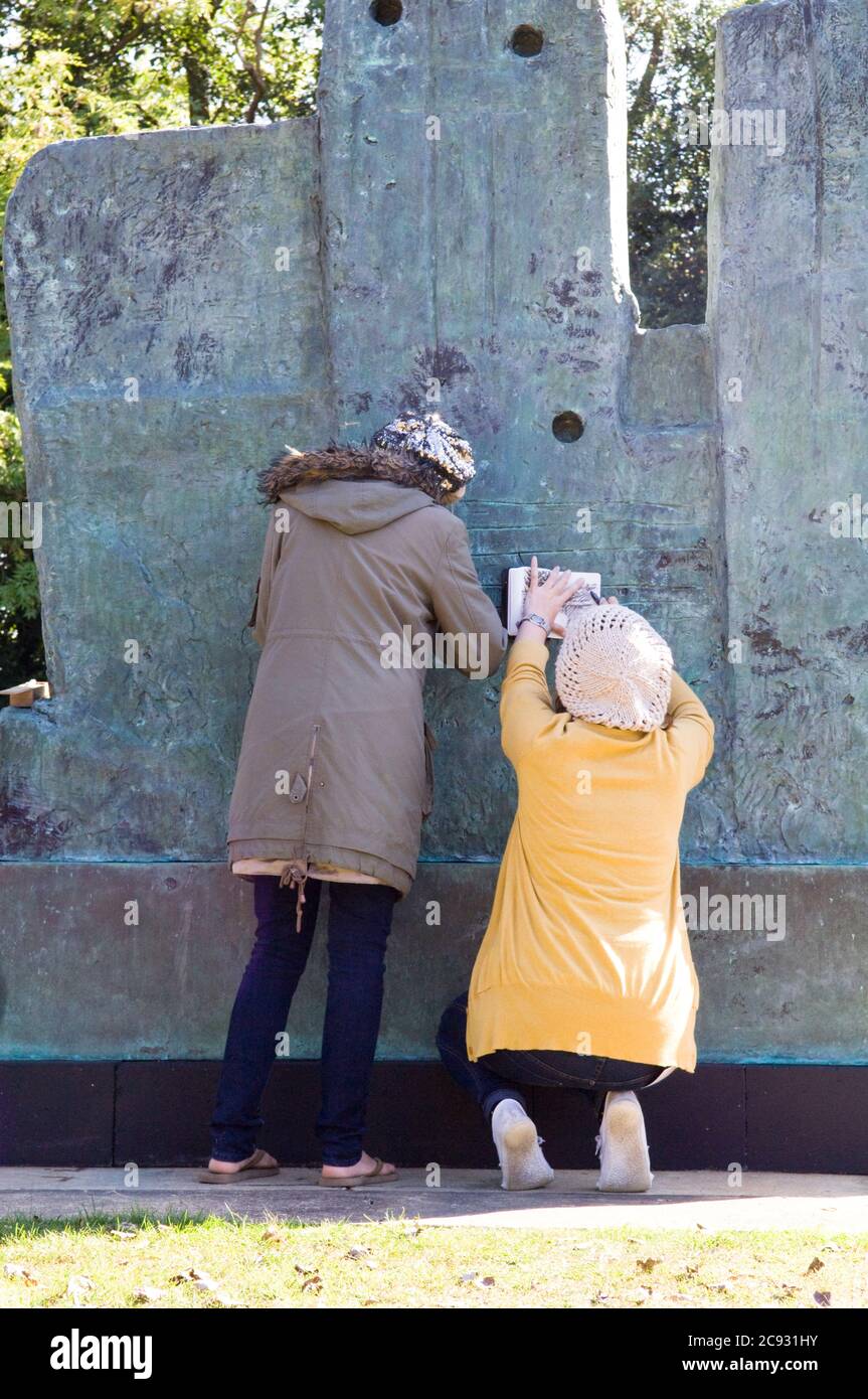 Two students take rubbings from a sculpture at the Henry Moore ...