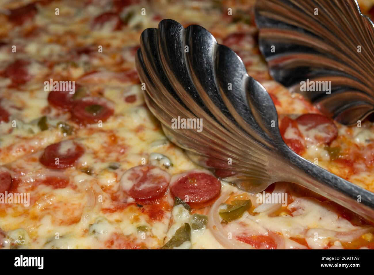 Homemade pizza with sausage, mushrooms and mozzarella cheese and metal ...