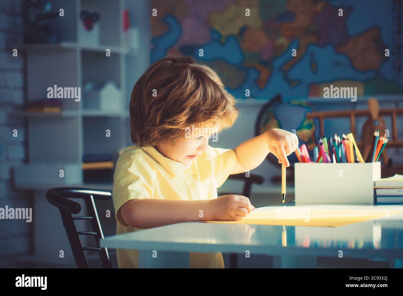 Young boy painting decorative lettering with pen color paint Stock ...