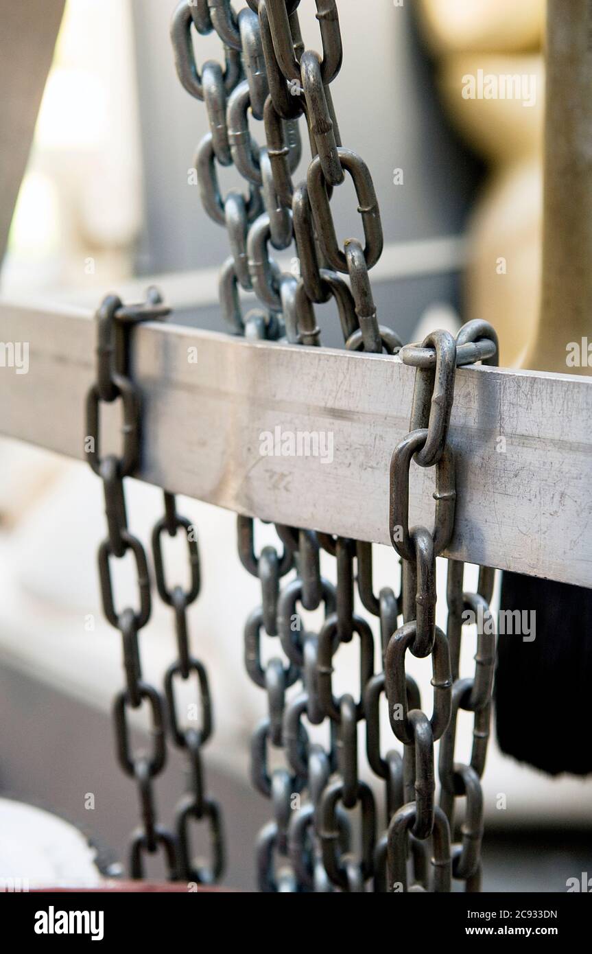 A chain wrapped around a piece of wood Stock Photo - Alamy