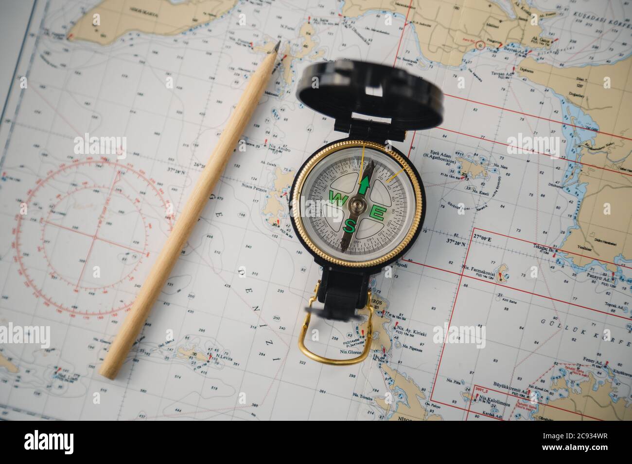 Magnetic compass and pencil lying on map with rope. Top view Stock ...