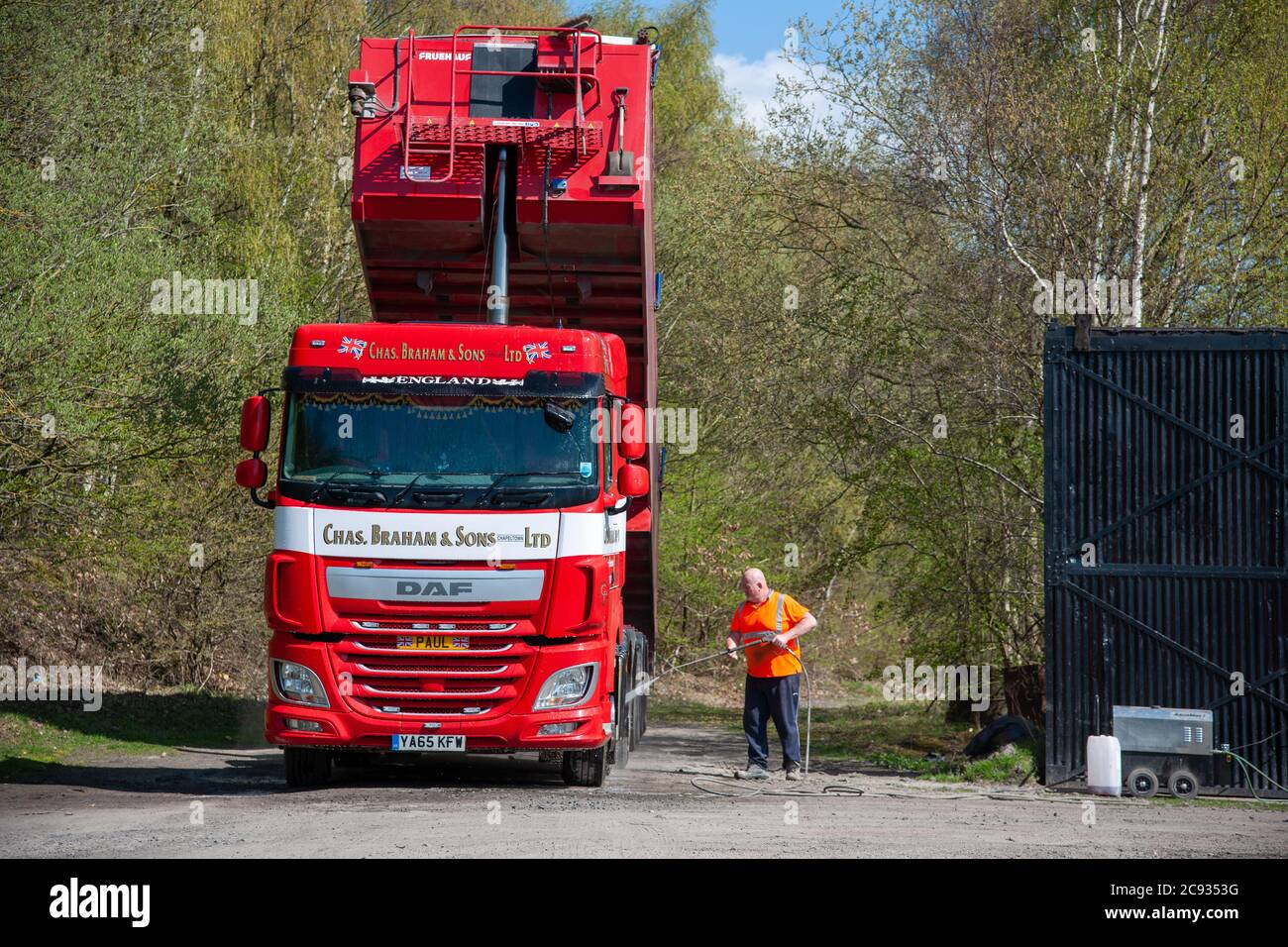 Haulage company owner operator jet washing his DAF XF truck and bulk ...