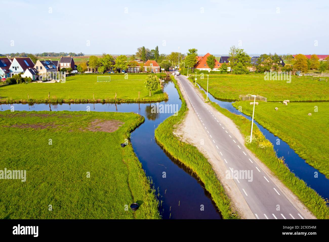 Aerial from a typical dutch landscape: flat meadows, canals and ...