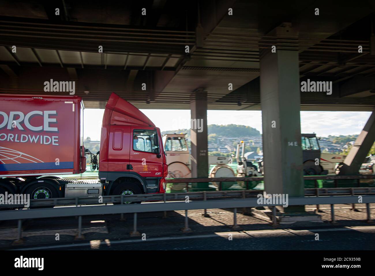 Royal Mail Parcel Force DAF truck and steel box trailer passing road ...