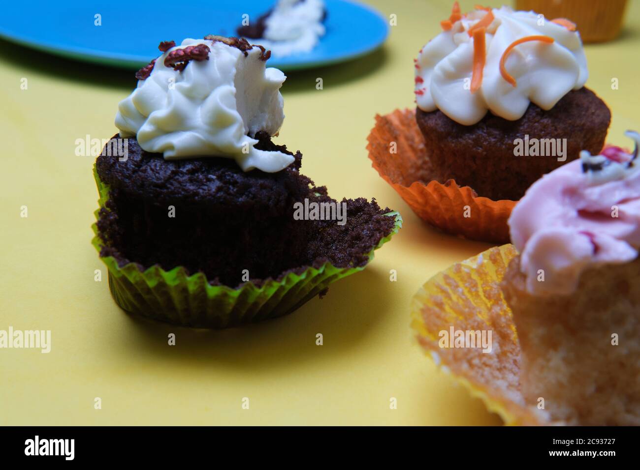 Closeup shot of cute cupcakes with a bitten chocolate one Stock Photo ...